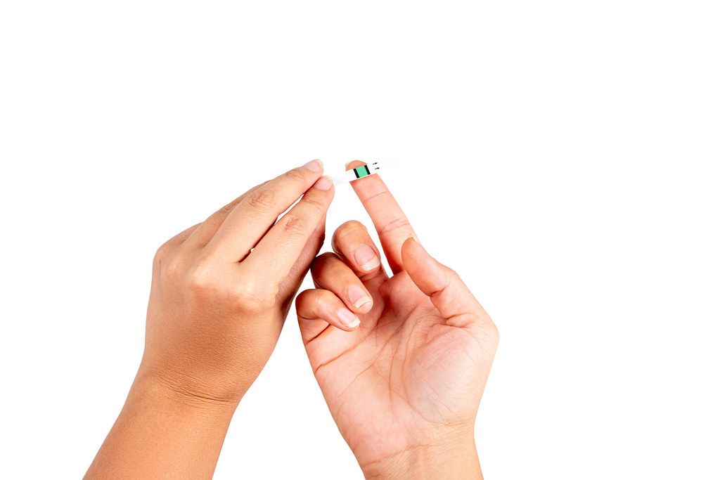 Piercing A Finger Close Up Person s Hand Checking Blood Sugar Level Piercing A Finger Close Up Person s Hand Checking Blood Sugar Level